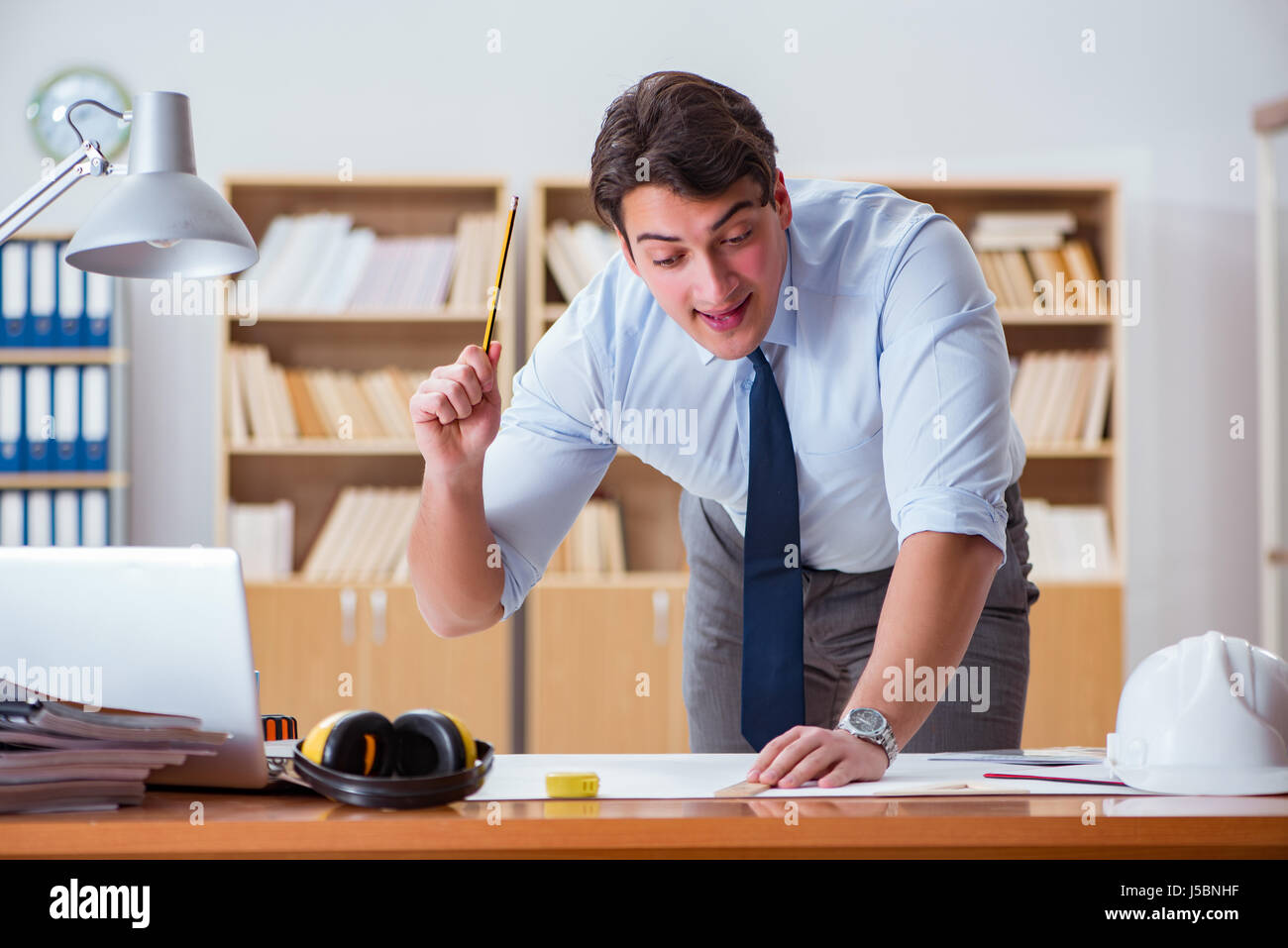 Engineer supervisor working on drawings in the office Stock Photo - Alamy