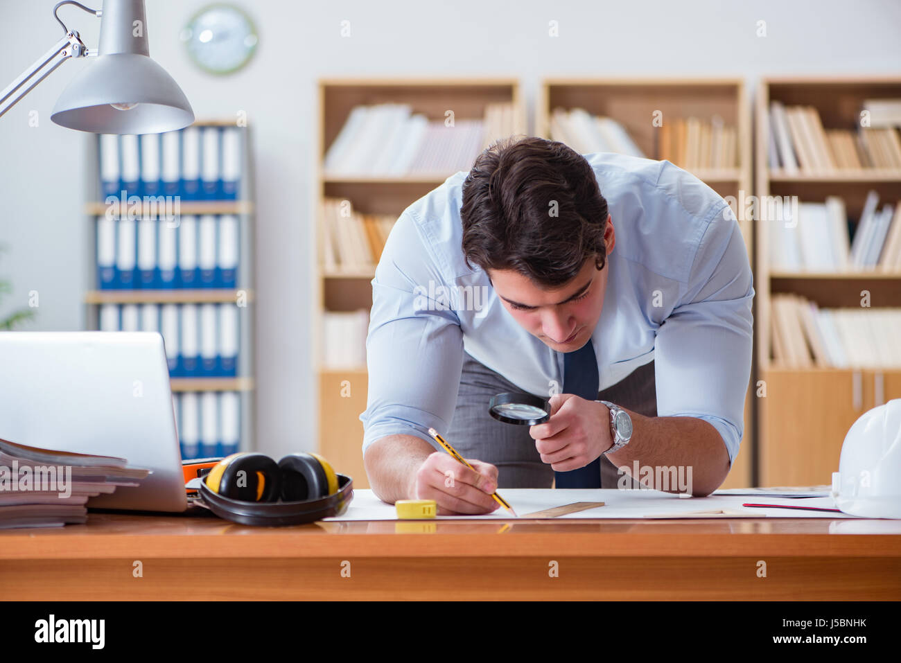 Engineer supervisor working on drawings in the office Stock Photo - Alamy