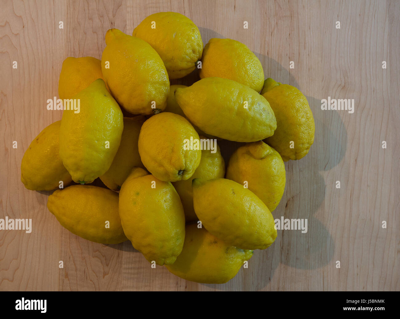 A Stack Of Organic Lemons On A Wooden Board Stock Photo - Alamy