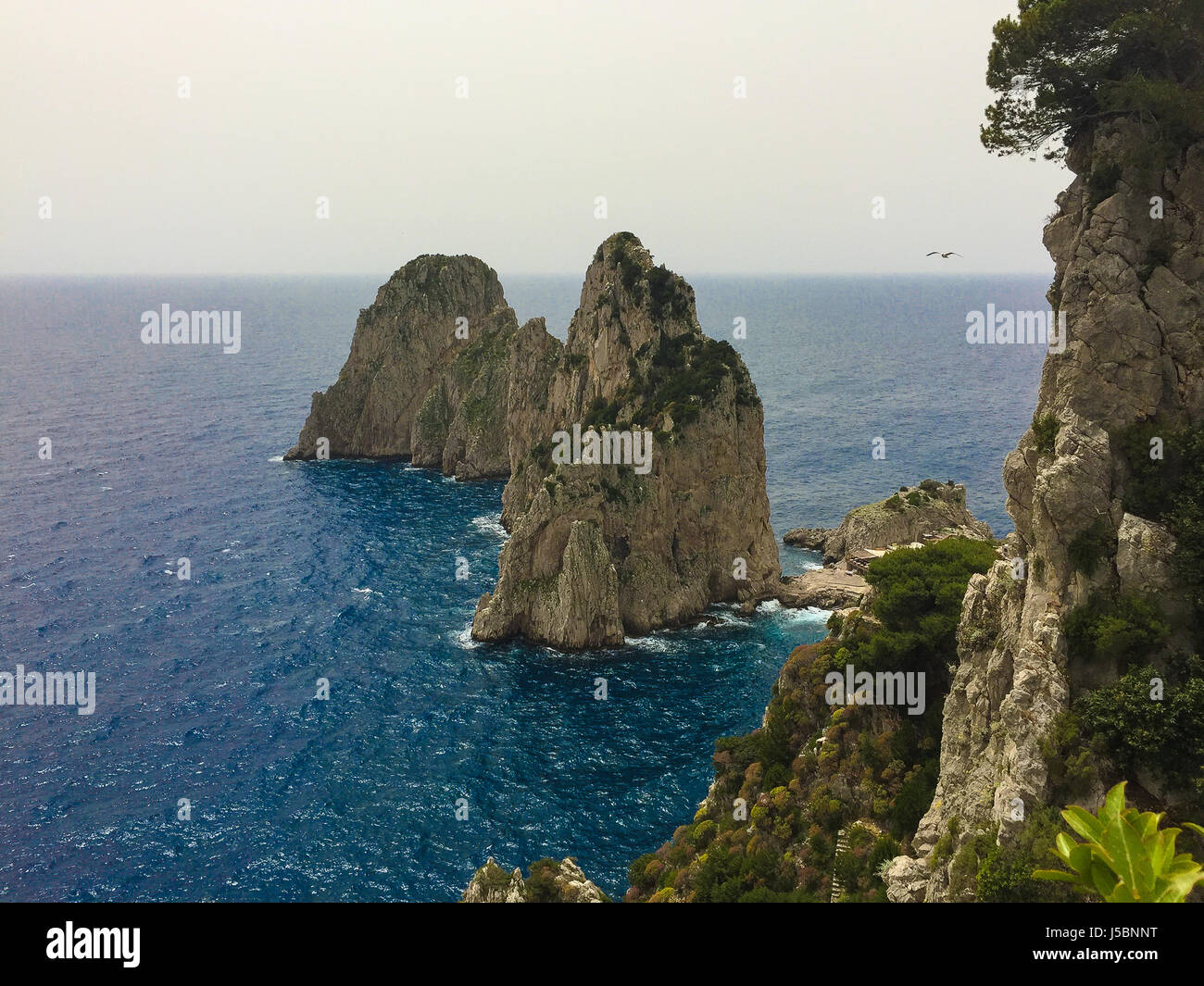 Giant Rocks In The Blue Sea Stock Photo - Alamy