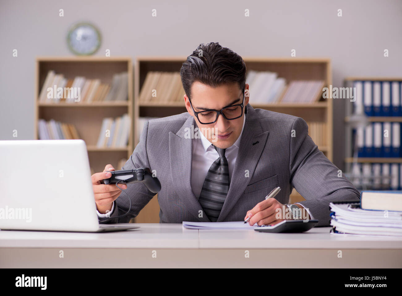 Businessman playing computer games at work office Stock Photo - Alamy