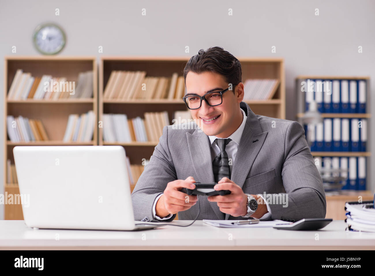 Businessman playing computer games at work office Stock Photo - Alamy