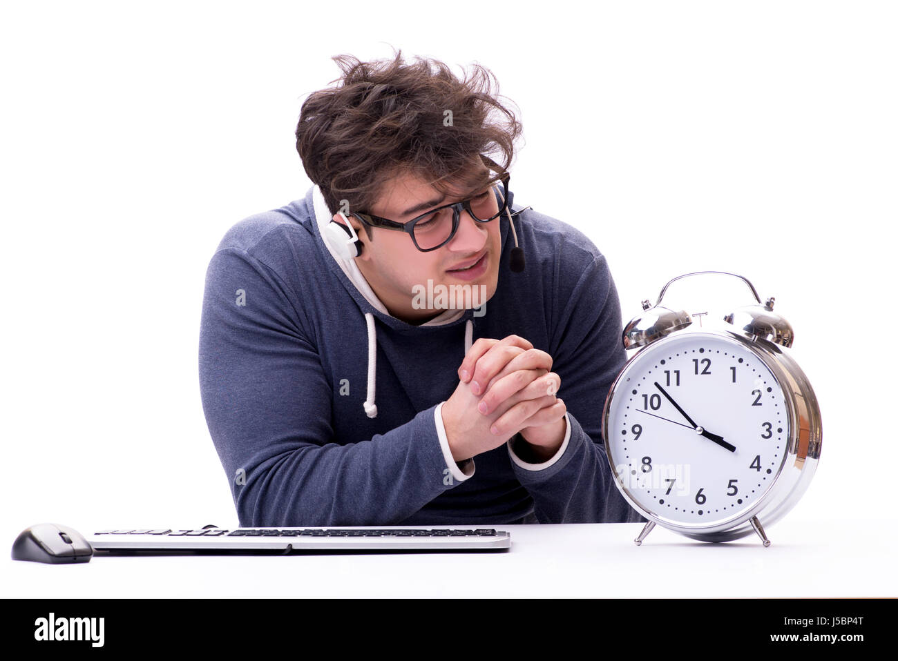Funny nerd call center operator with giant clock Stock Photo - Alamy