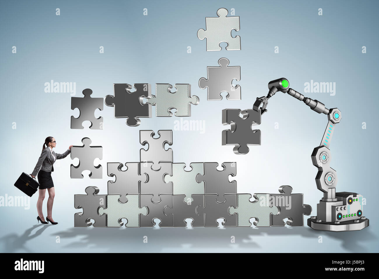 Businesswoman doing jigsaw puzzle with robotic arm Stock Photo - Alamy