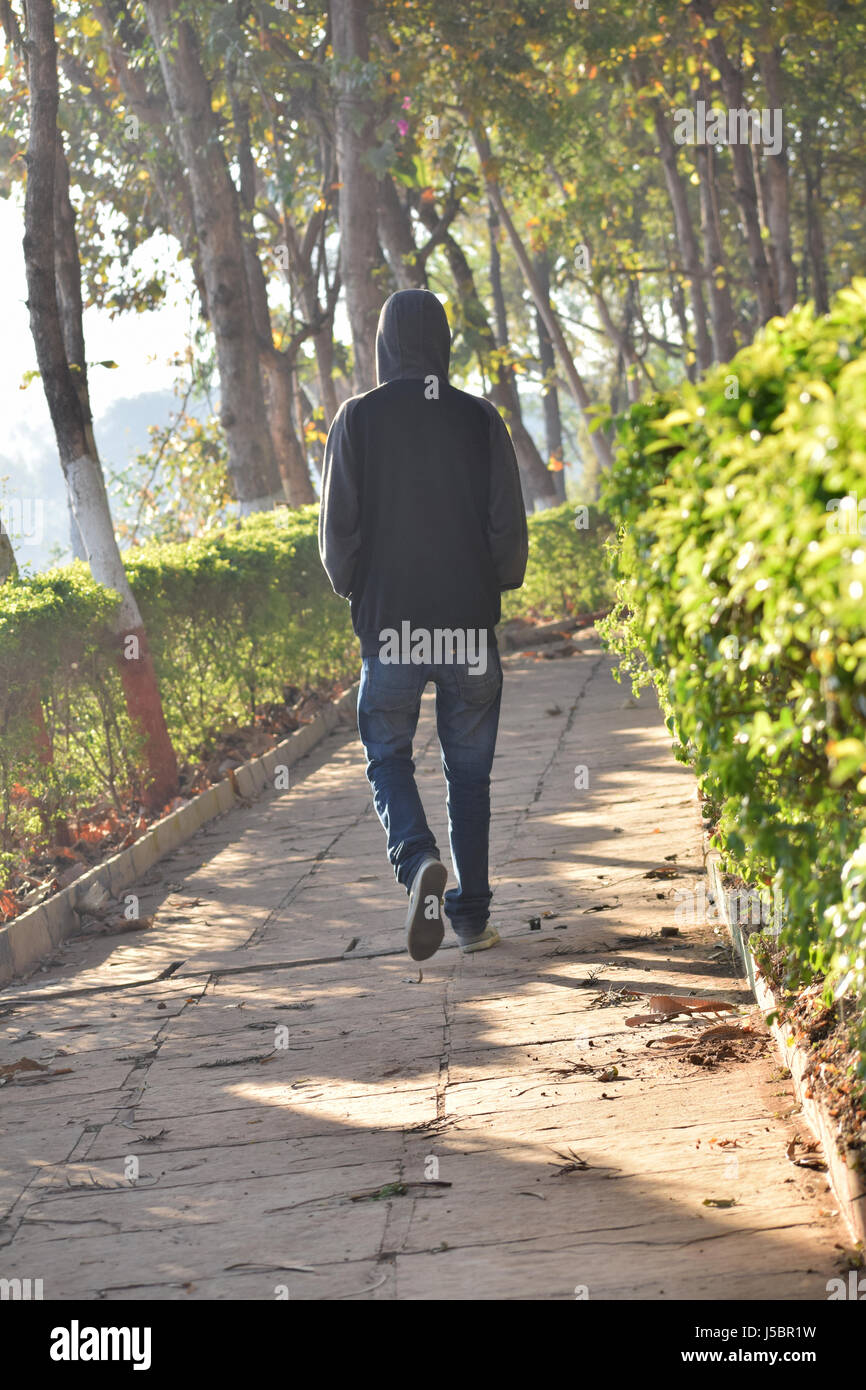 Young man walking in a garden, Pune, Maharashtra Stock Photo - Alamy