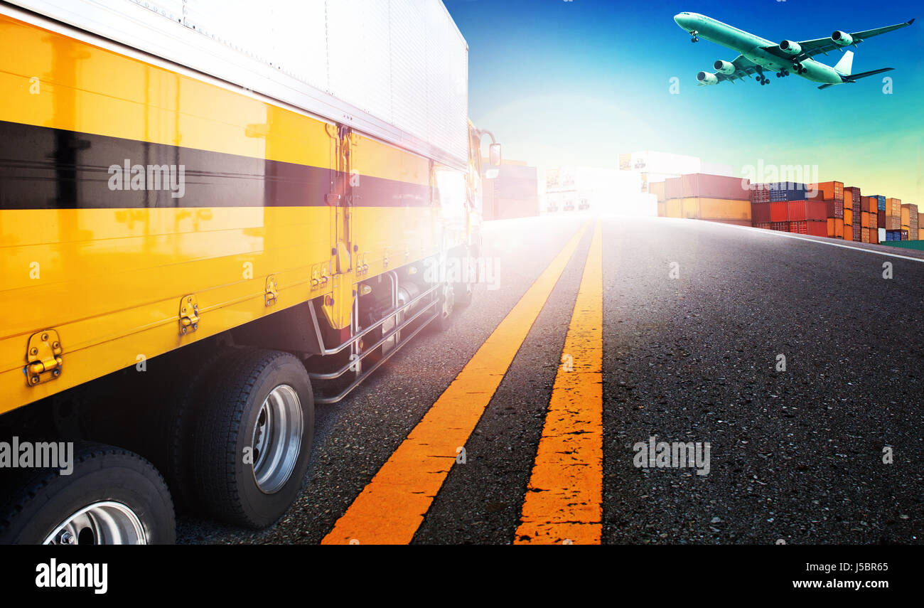 container truck and freight cargo plane flying over ship yard for ...