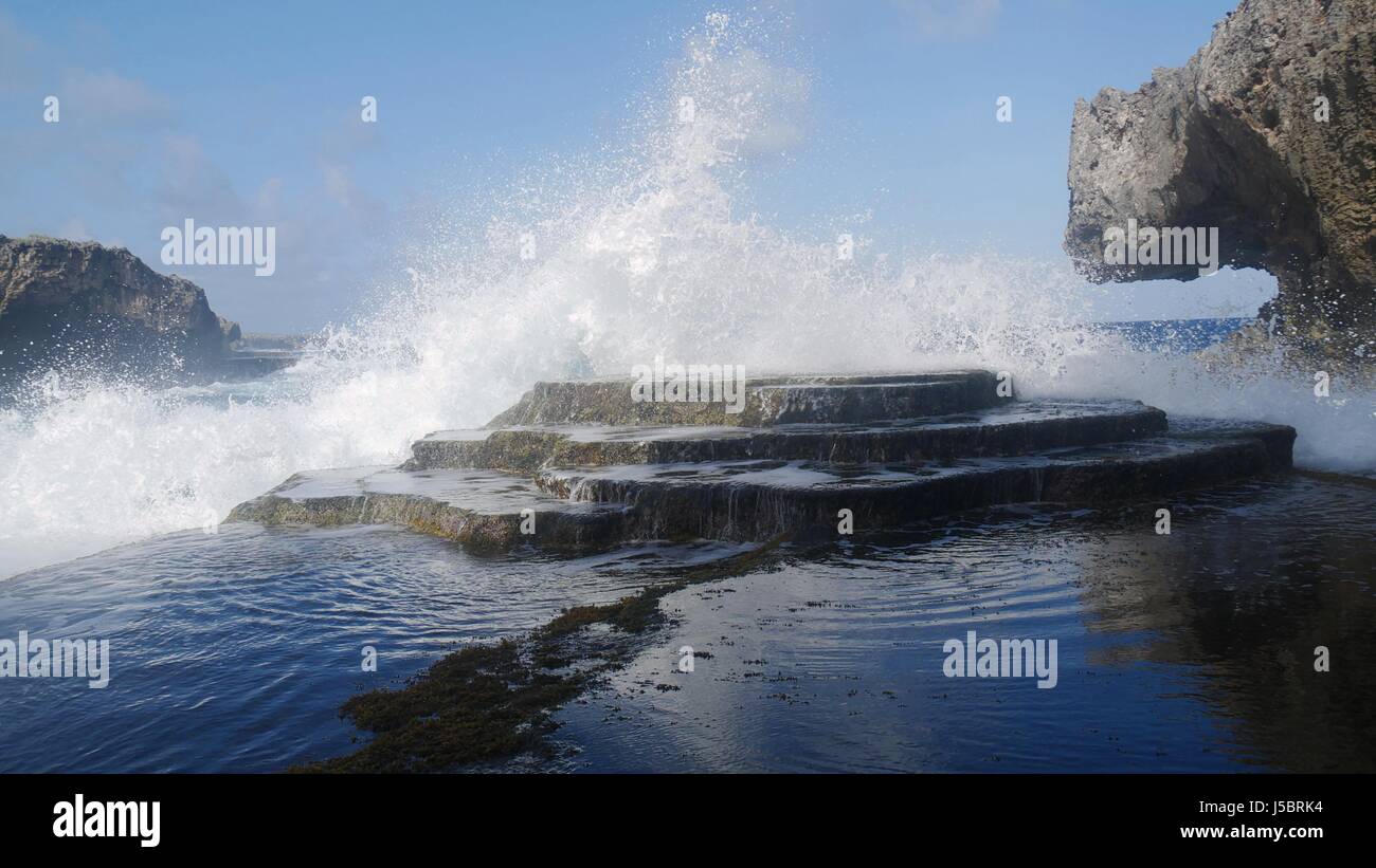 Mesmerizing splash against a stone platform Giant waves crash against a ...