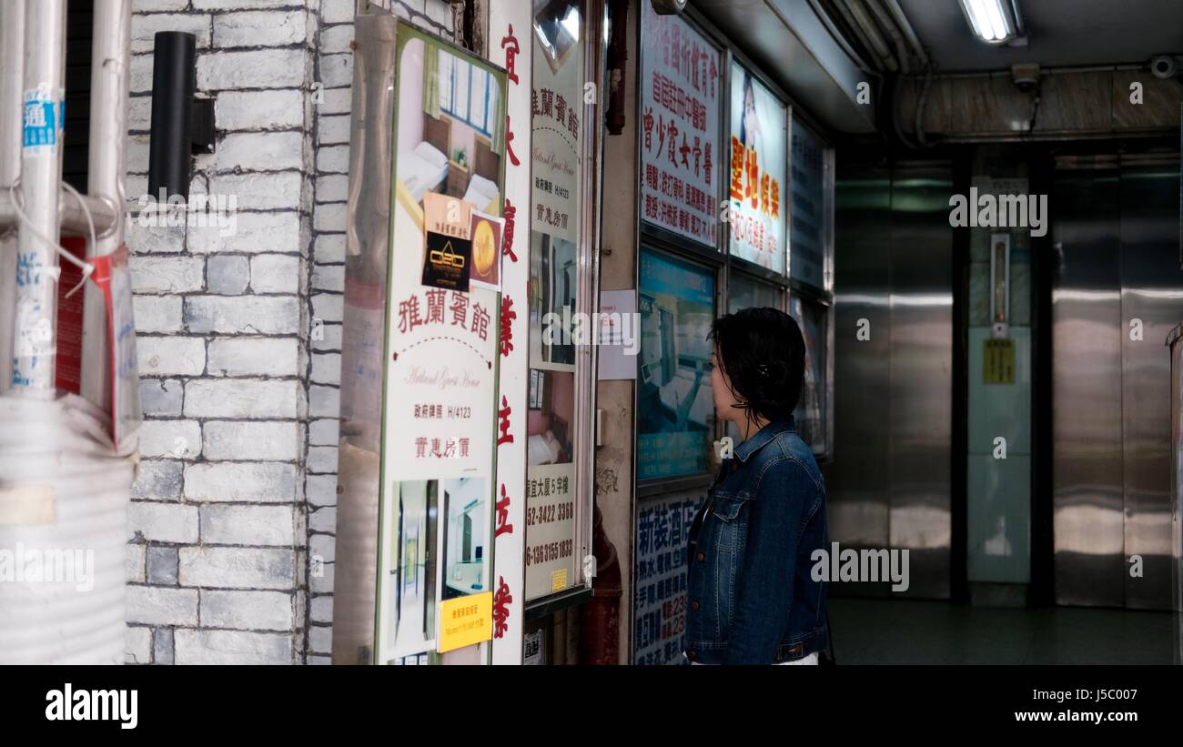Lady Reading Posters in Hallway on Nathan Road Mongkok Kowloon Hong ...