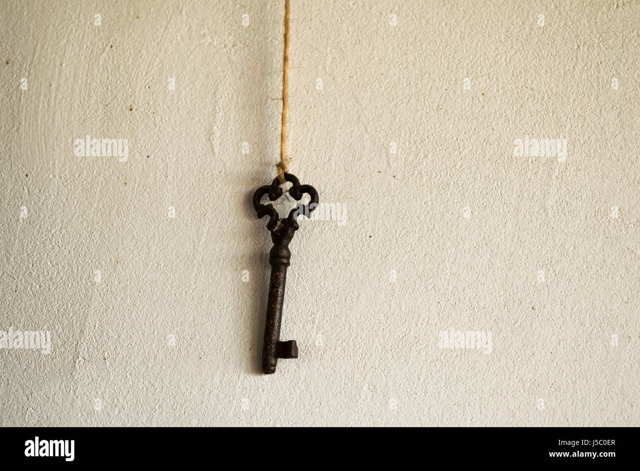 A key hanging on a rope Stock Photo - Alamy