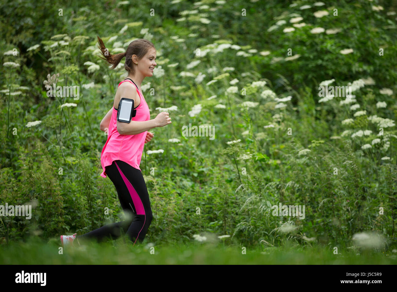 Athletic woman running outdoors. Action and healthy lifestyle concept ...