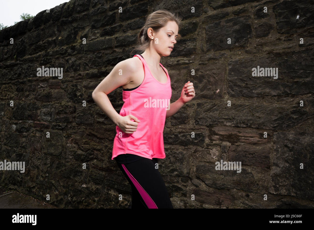 Athletic woman running outdoors. Action and healthy lifestyle concept ...