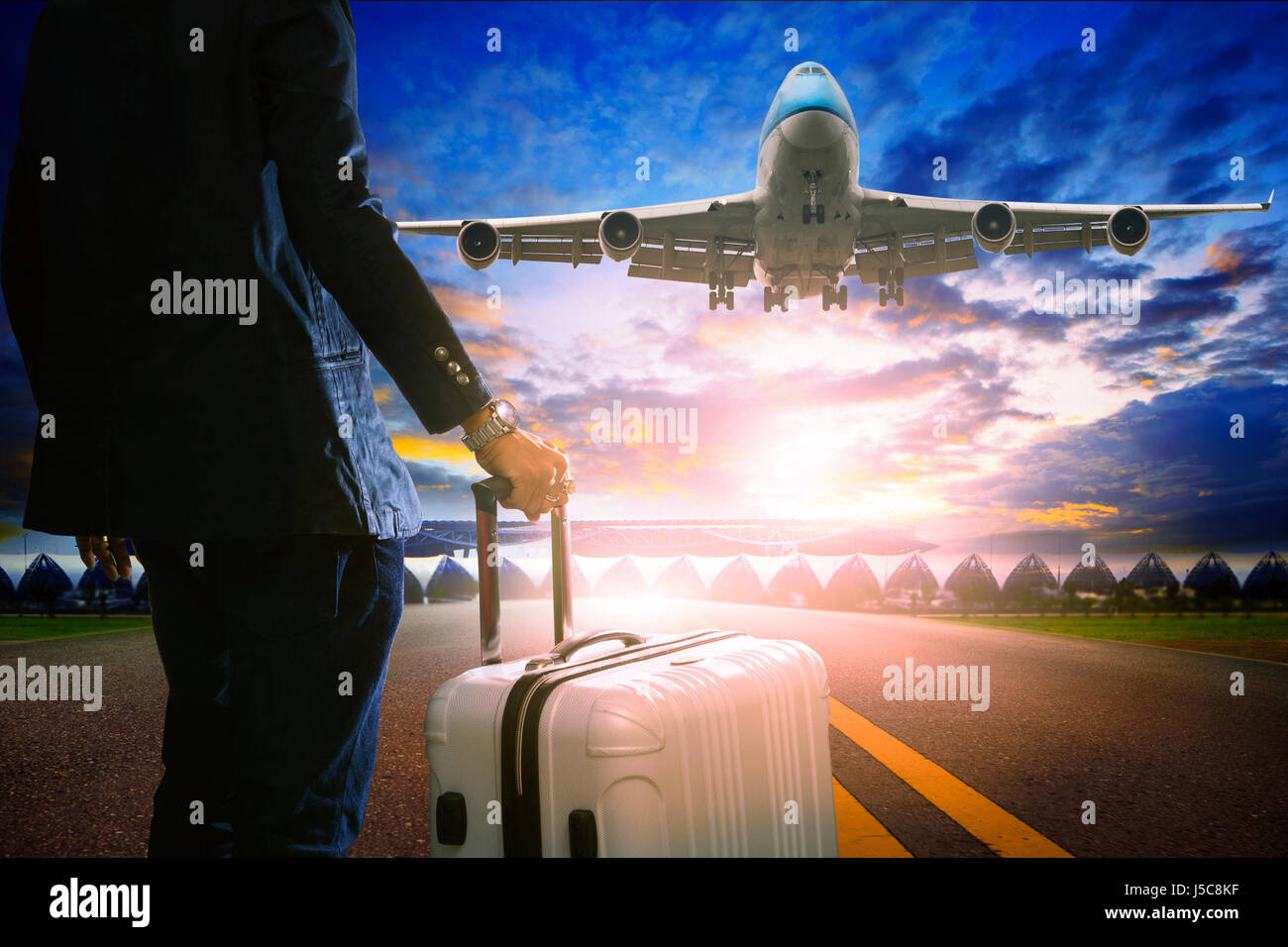 business man and luggage standing in airport and passenger jet plane ...