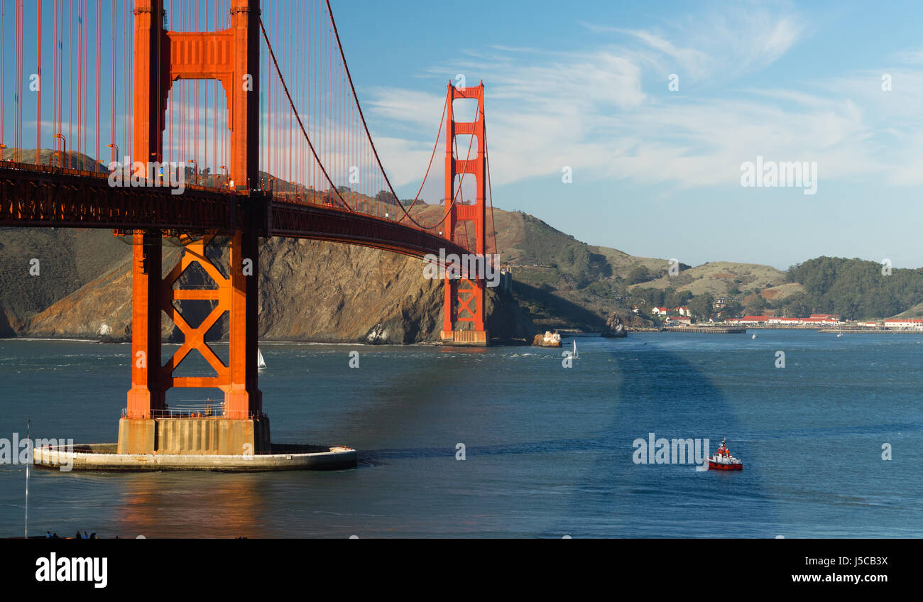 A pilot boat awaits a large cargo ship to enter the bay under the ...