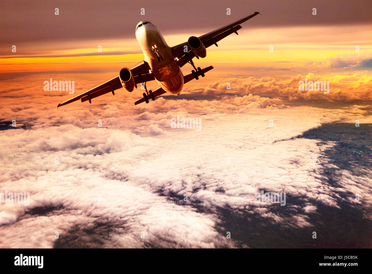 passenger jet plane take off to mid air against beautiful golden light ...