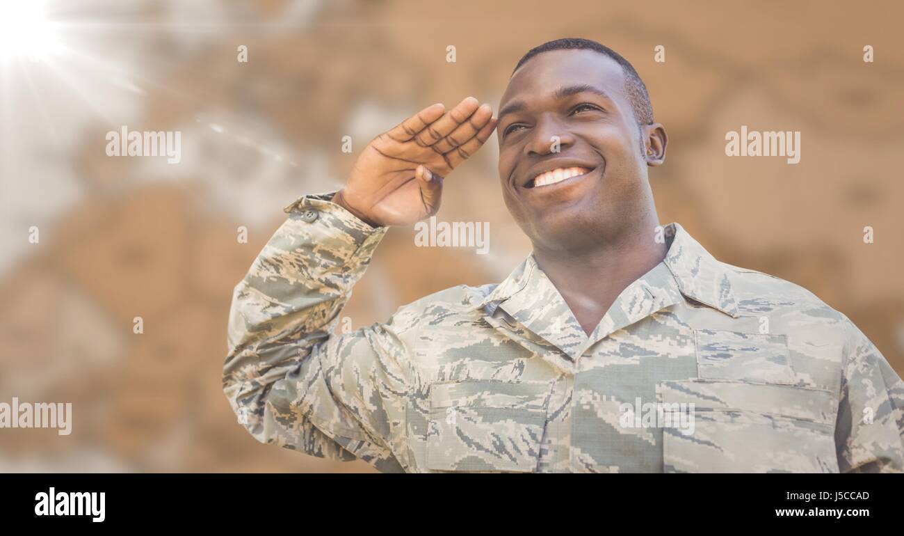 Digital composite of Soldier smiling and saluting against blurry brown ...