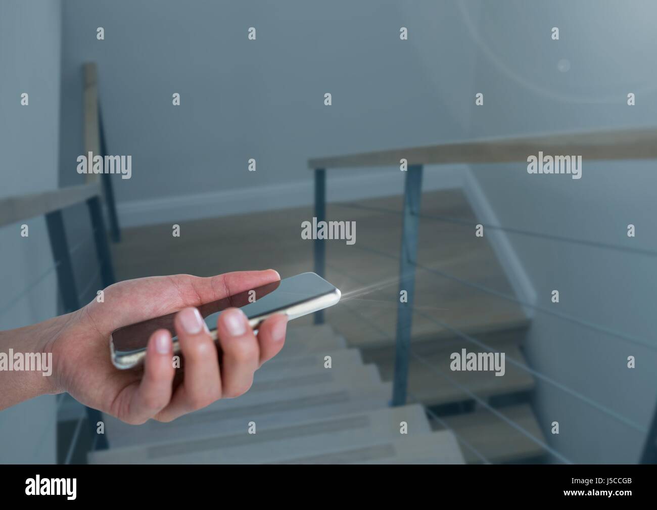 Digital composite of Hand holding a mobile phone device on stairs Stock ...
