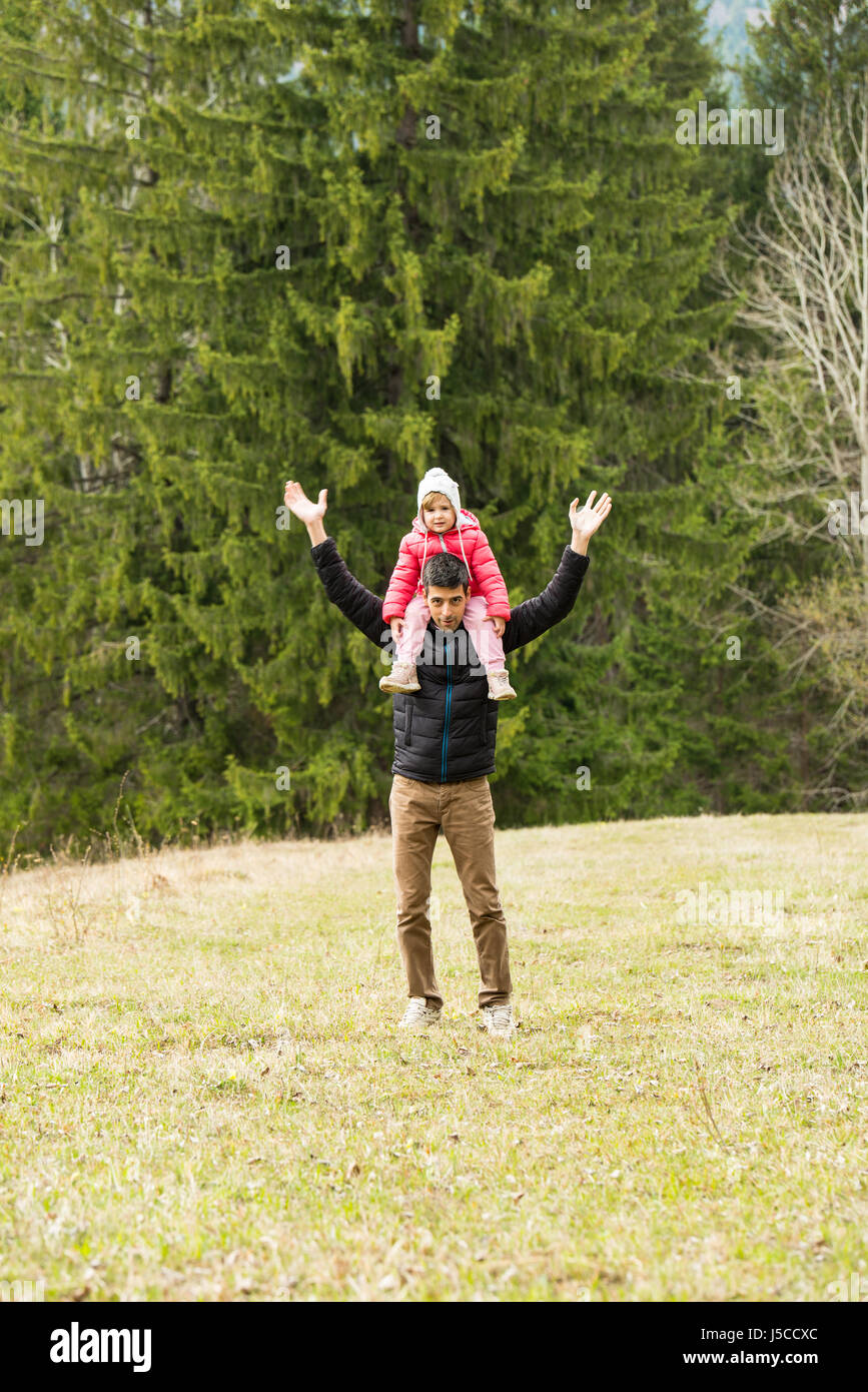 Cheerful dad and daughter having a walk in nature Stock Photo - Alamy