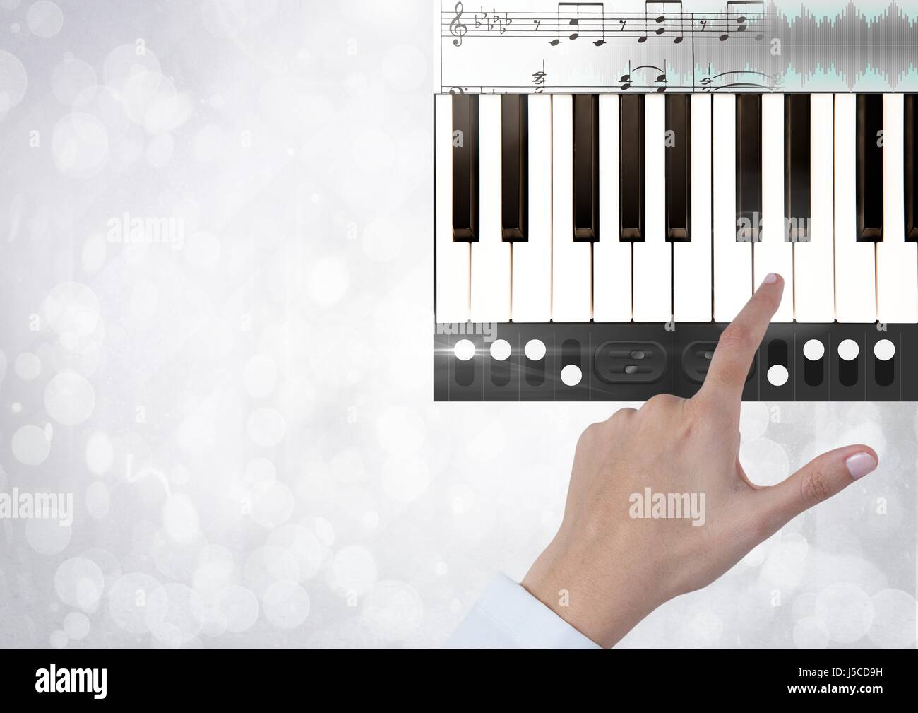 Digital composite of Hand Touching Piano keys with notes and effects ...