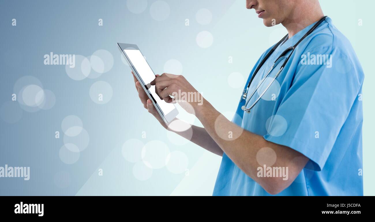 Digital composite of Doctor mid section touching tablet with bokeh ...