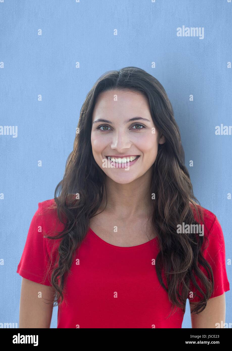 Digital composite of Young woman with long brown hair smiling over blue ...