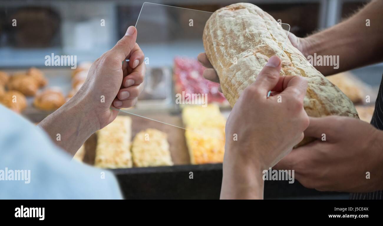 Digital composite of Hands photographing bread through transparent ...