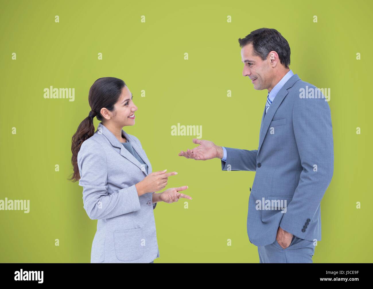 Digital composite of Business people talking against green background ...