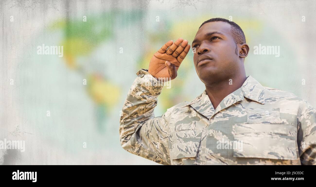 Digital composite of Soldier saluting against blurry map with grunge ...