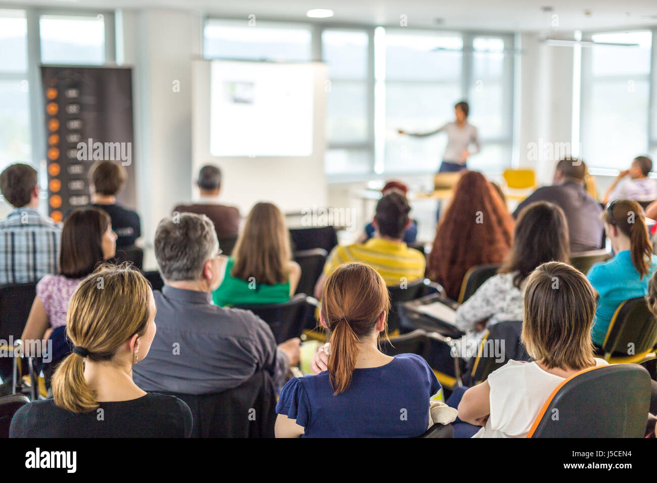 Woman giving presentation on business conference Stock Photo - Alamy