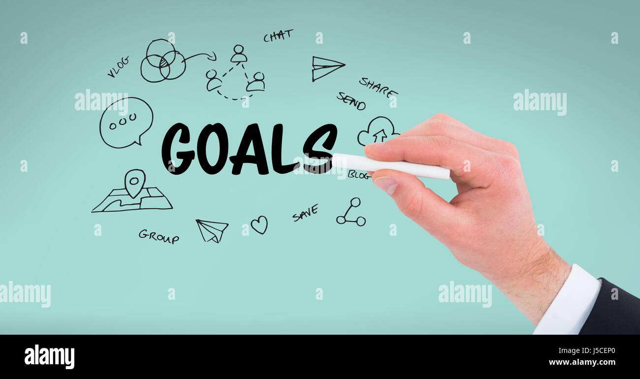 Digital composite of Businessman's hand drawing goals on green ...