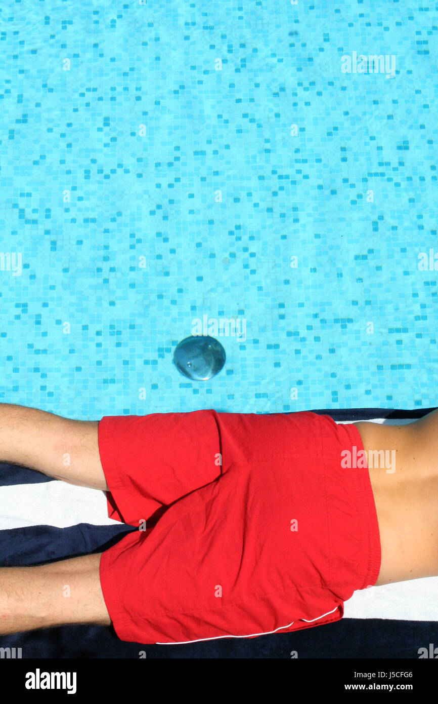 blue lie lying lies towel turquoise drain swimming trunks pool hip ...