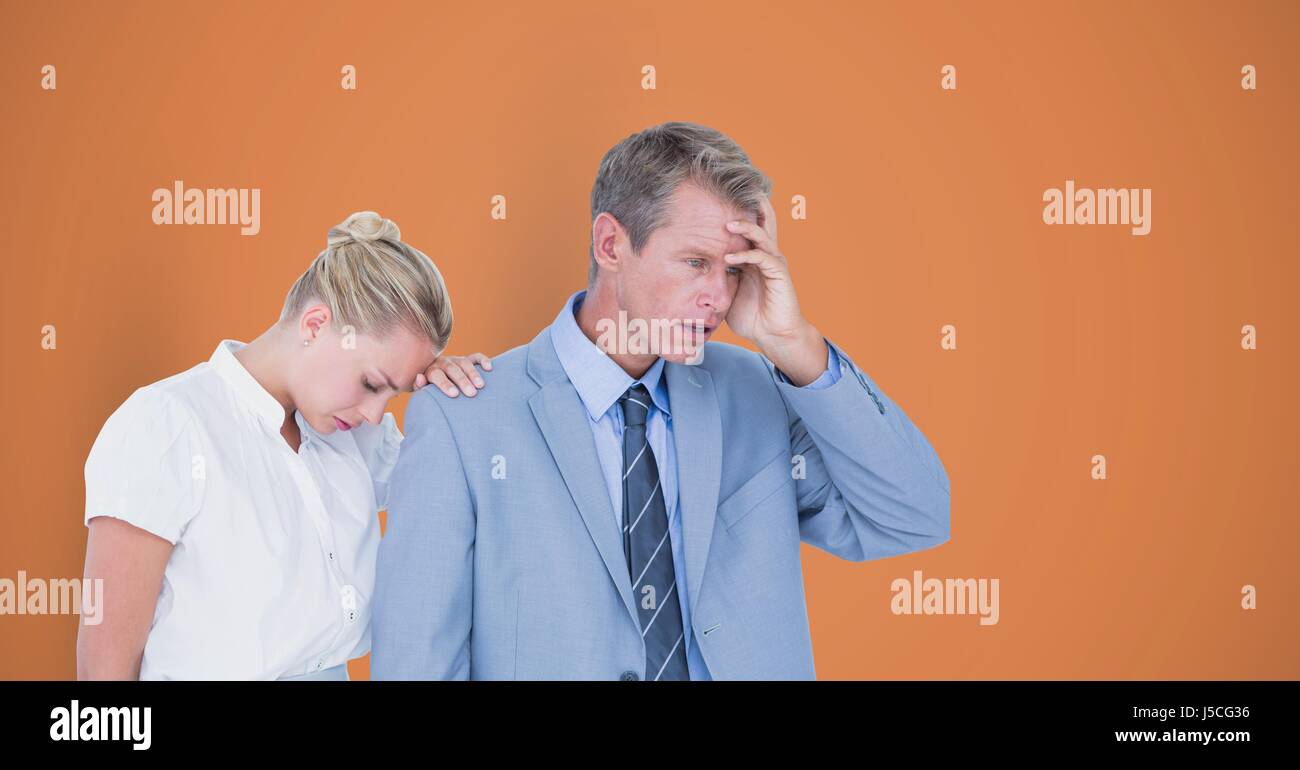Digital composite of Tensed business people over orange background ...