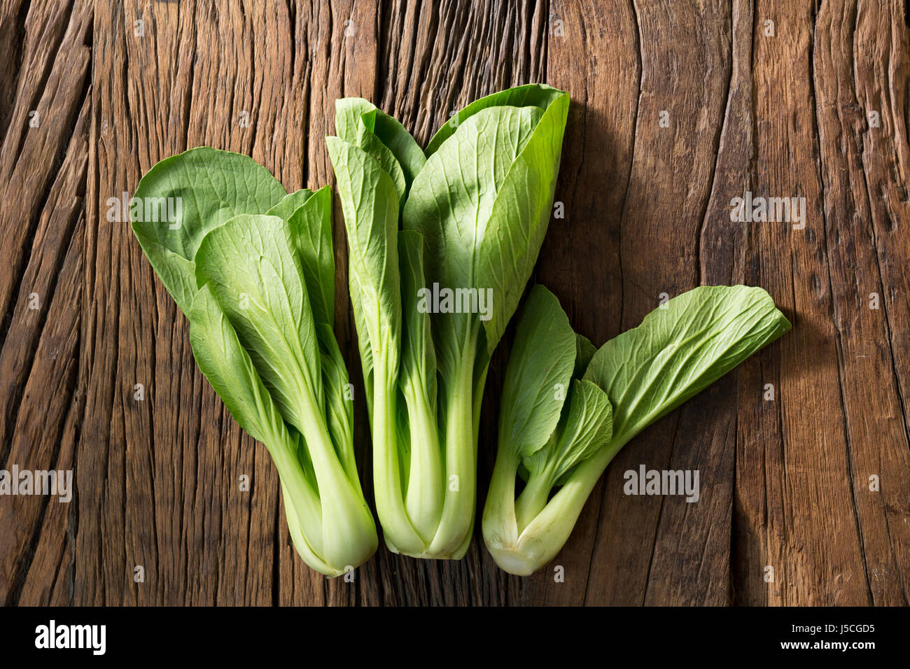 Bok choy or pak choi sitting on a rustic wooden background Stock Photo ...