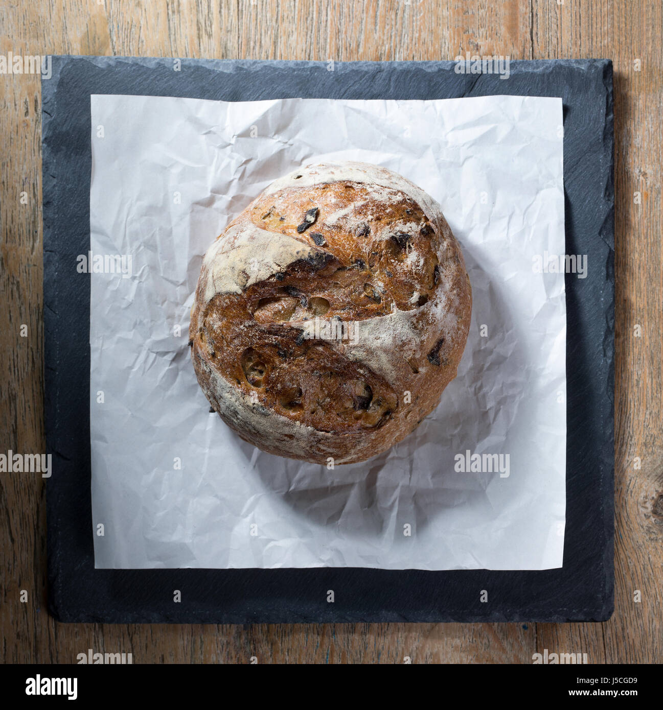 Round bread loaf on Black Slate Board Stock Photo - Alamy