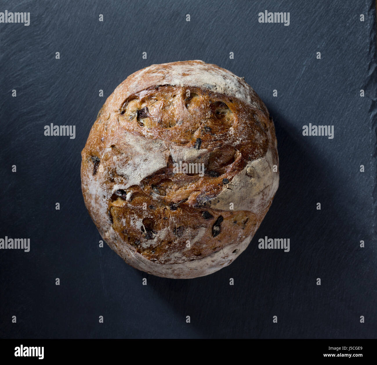 Round bread loaf on Black Slate Board Stock Photo - Alamy