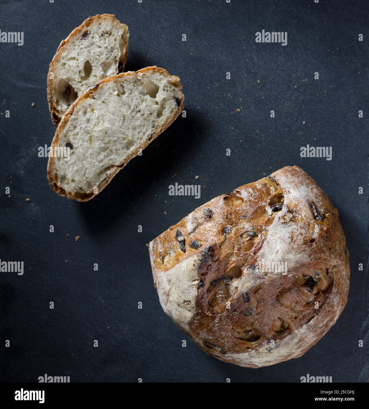 sliced bread loaf on Black Slate Board Stock Photo - Alamy