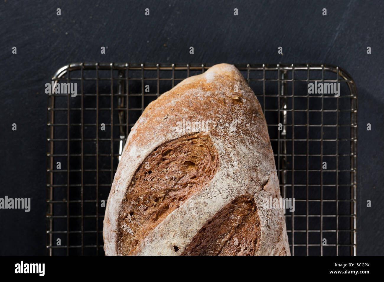 Rustic bread loaf on Black Slate Board Stock Photo - Alamy