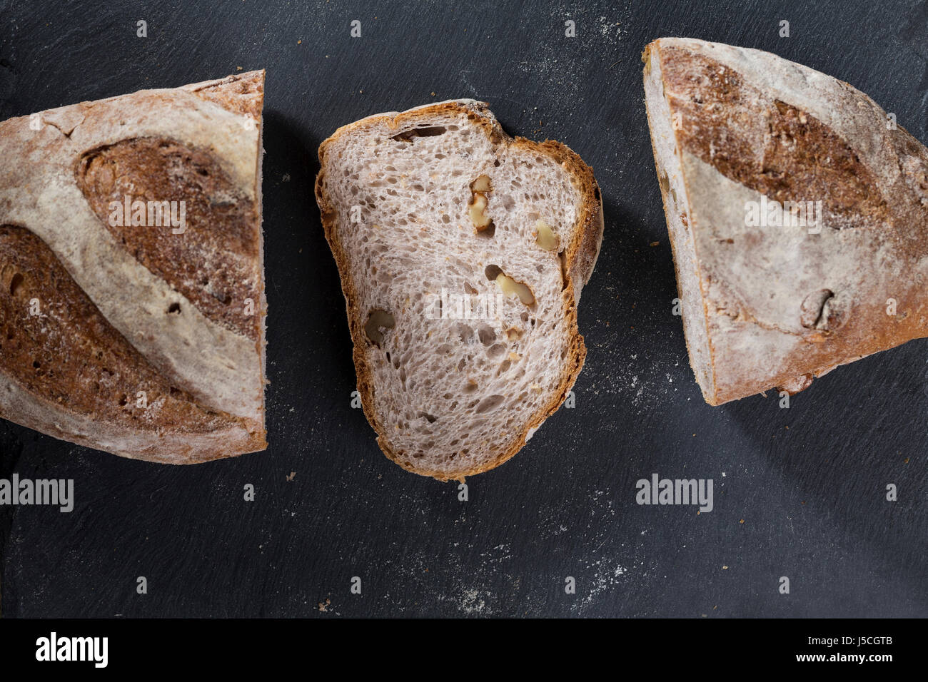 sliced bread loaf on Black Slate Board Stock Photo - Alamy