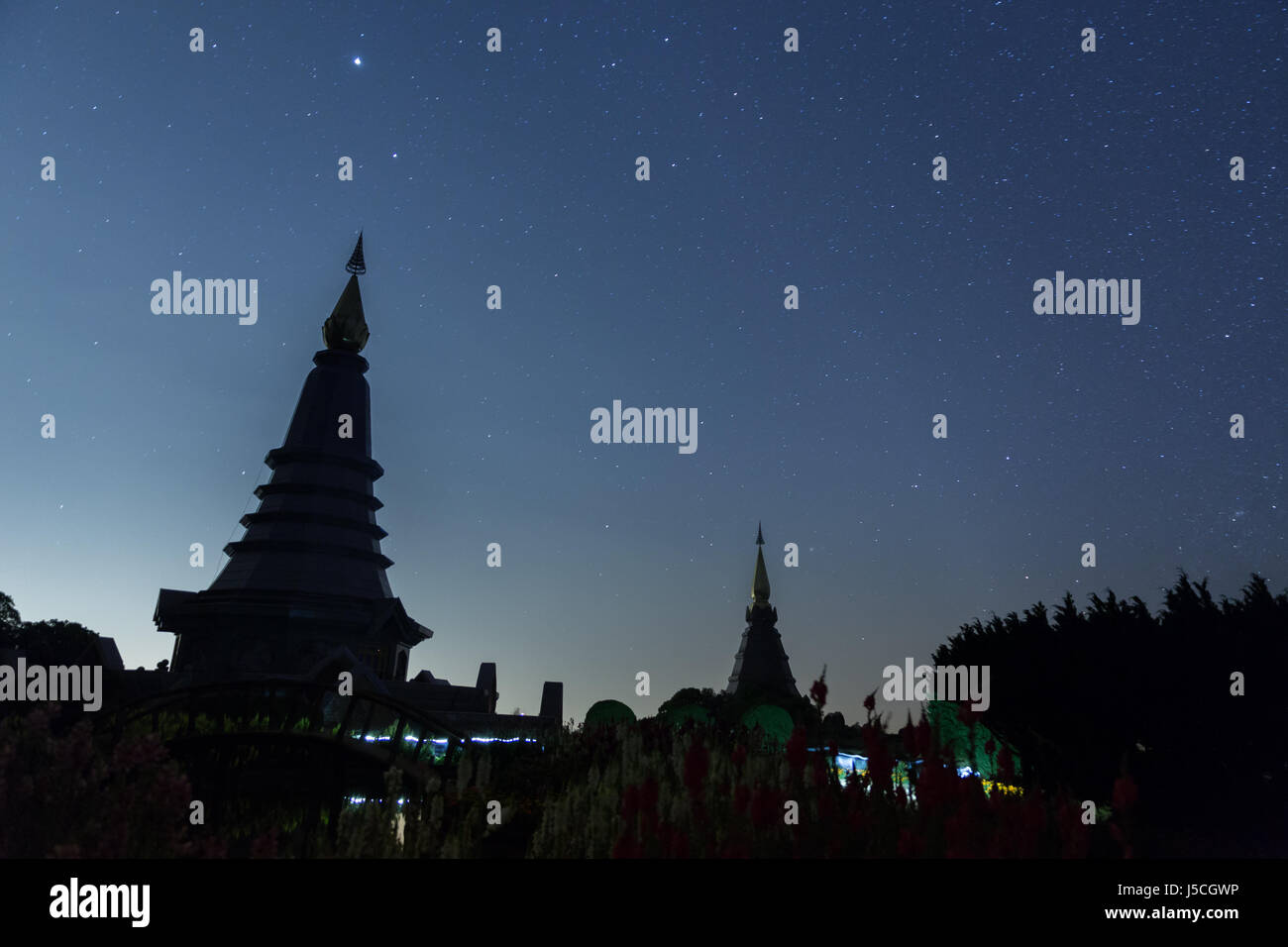 Night sky with lot of shiny stars and two pagoda in Doi Inthanon ...