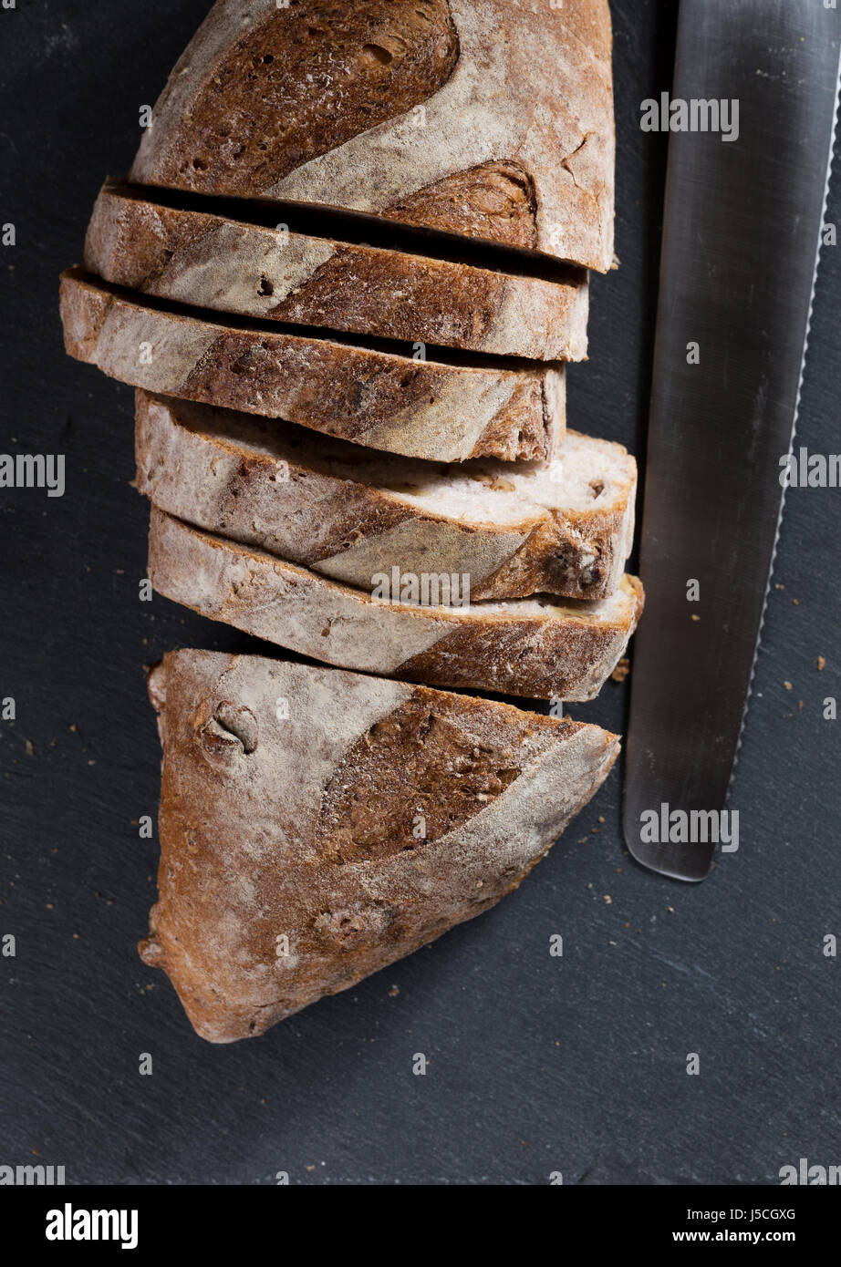 sliced bread loaf on Black Slate Board Stock Photo - Alamy