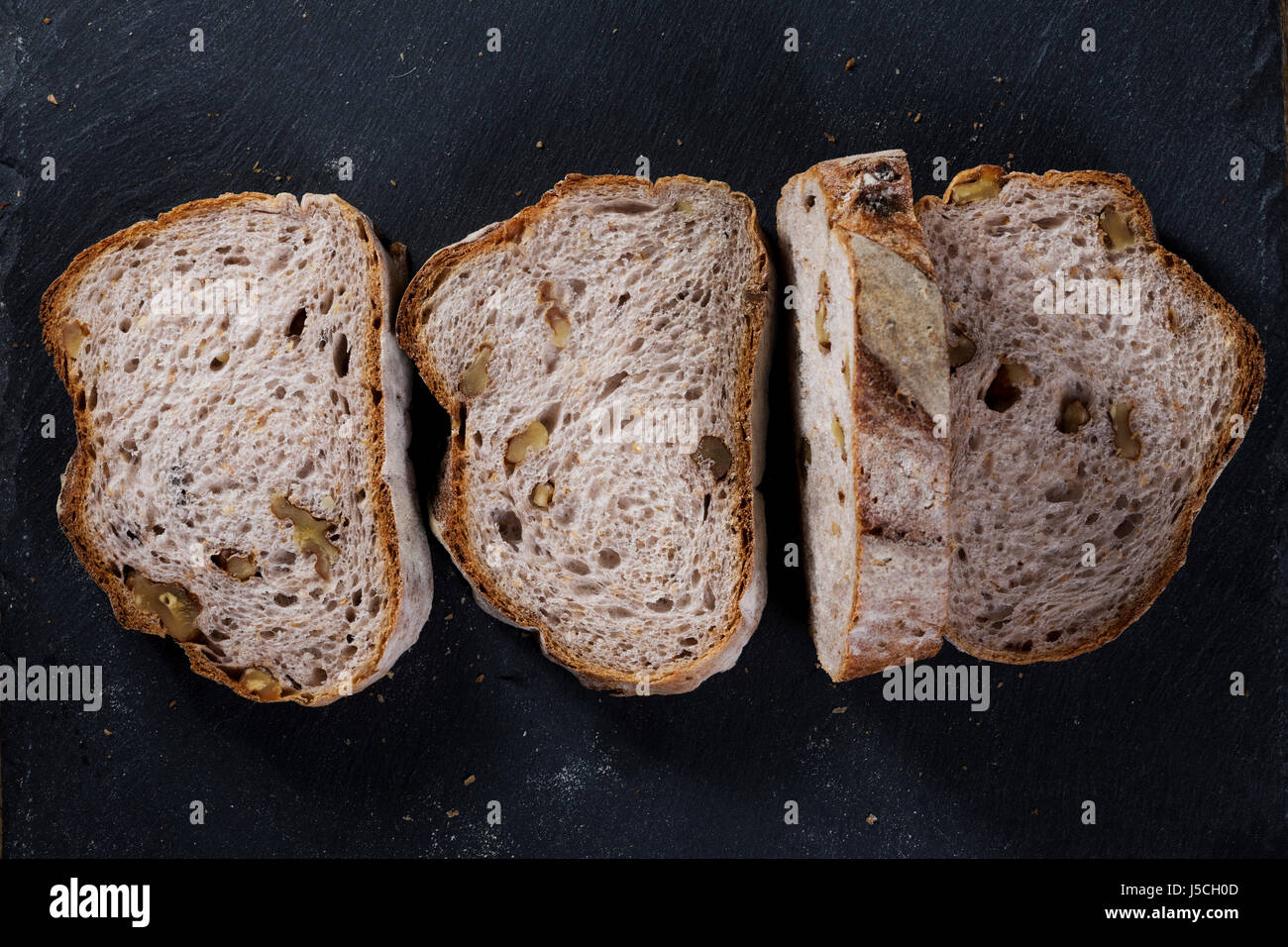 sliced bread loaf on Black Slate Board Stock Photo - Alamy