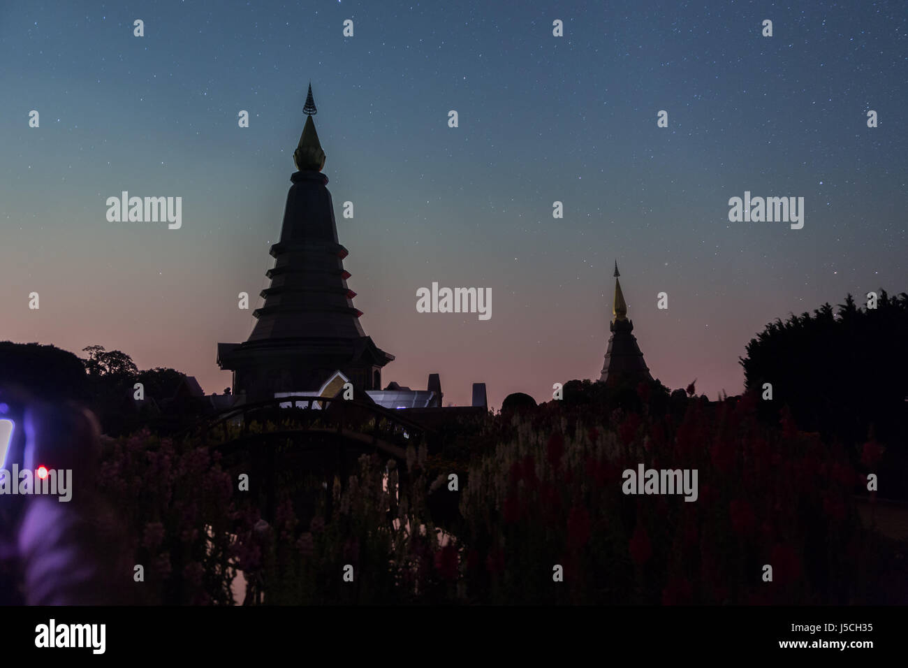 Night sky with lot of shiny stars and two pagoda in Doi Inthanon ...