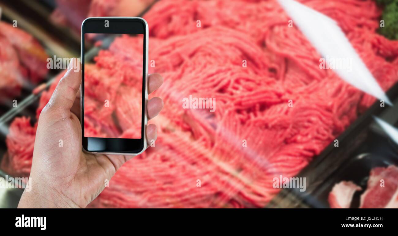 Digital composite of Hand taking picture of meat with smart phone at ...