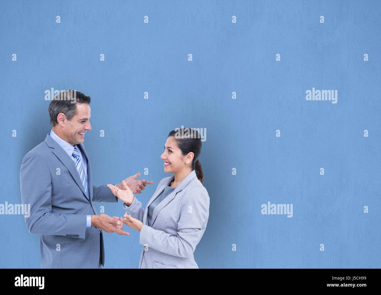 Digital composite of Happy business people talking against blue ...