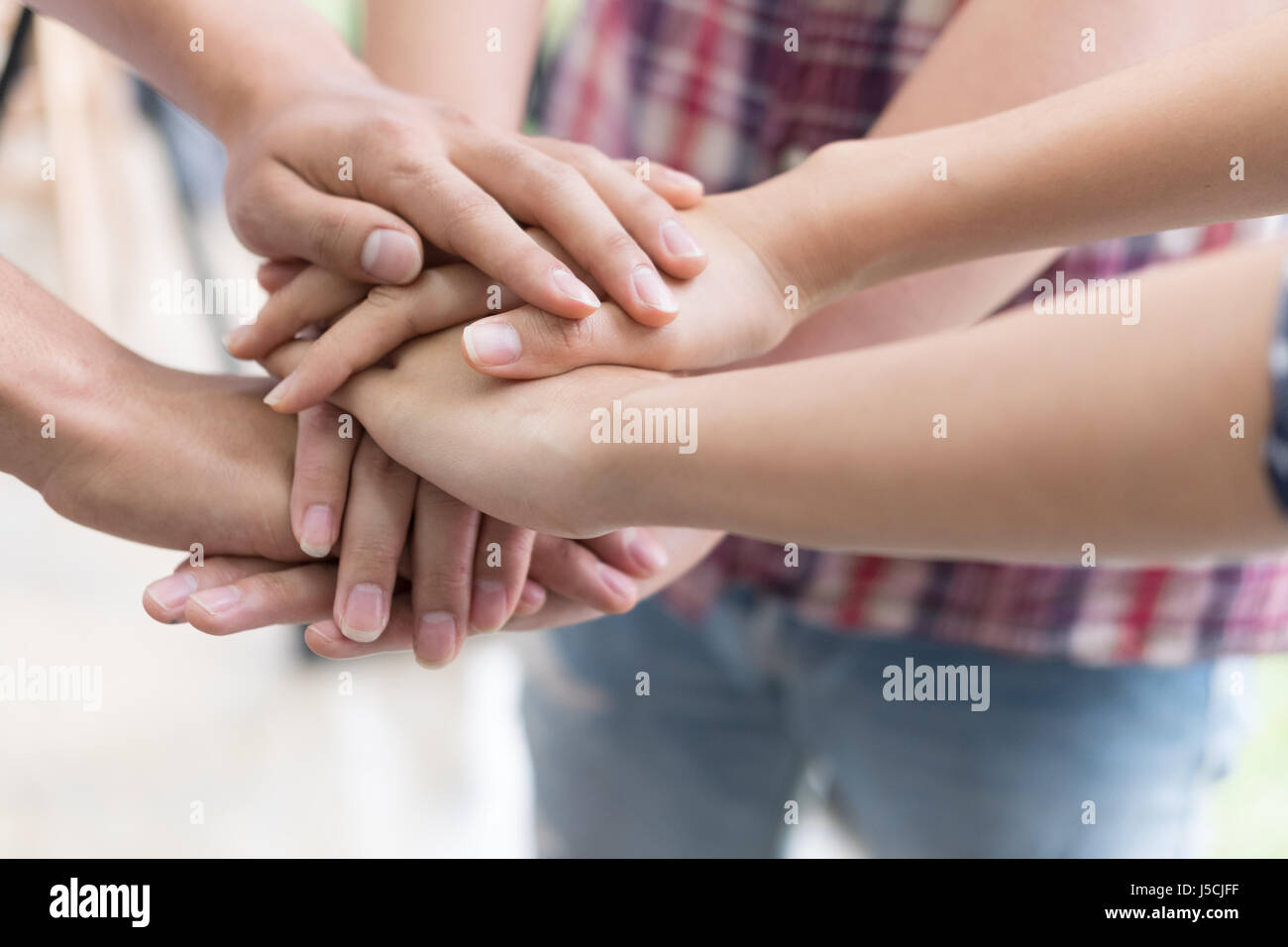 young college student joining united hand, business team touching hands ...