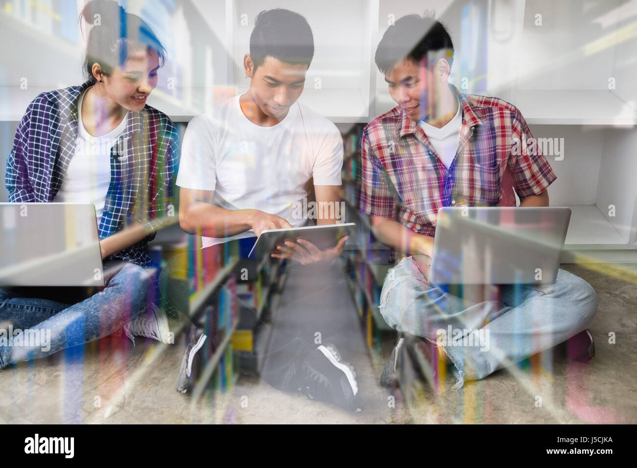 young asian people are using different gadgets and smiling, sitting ...