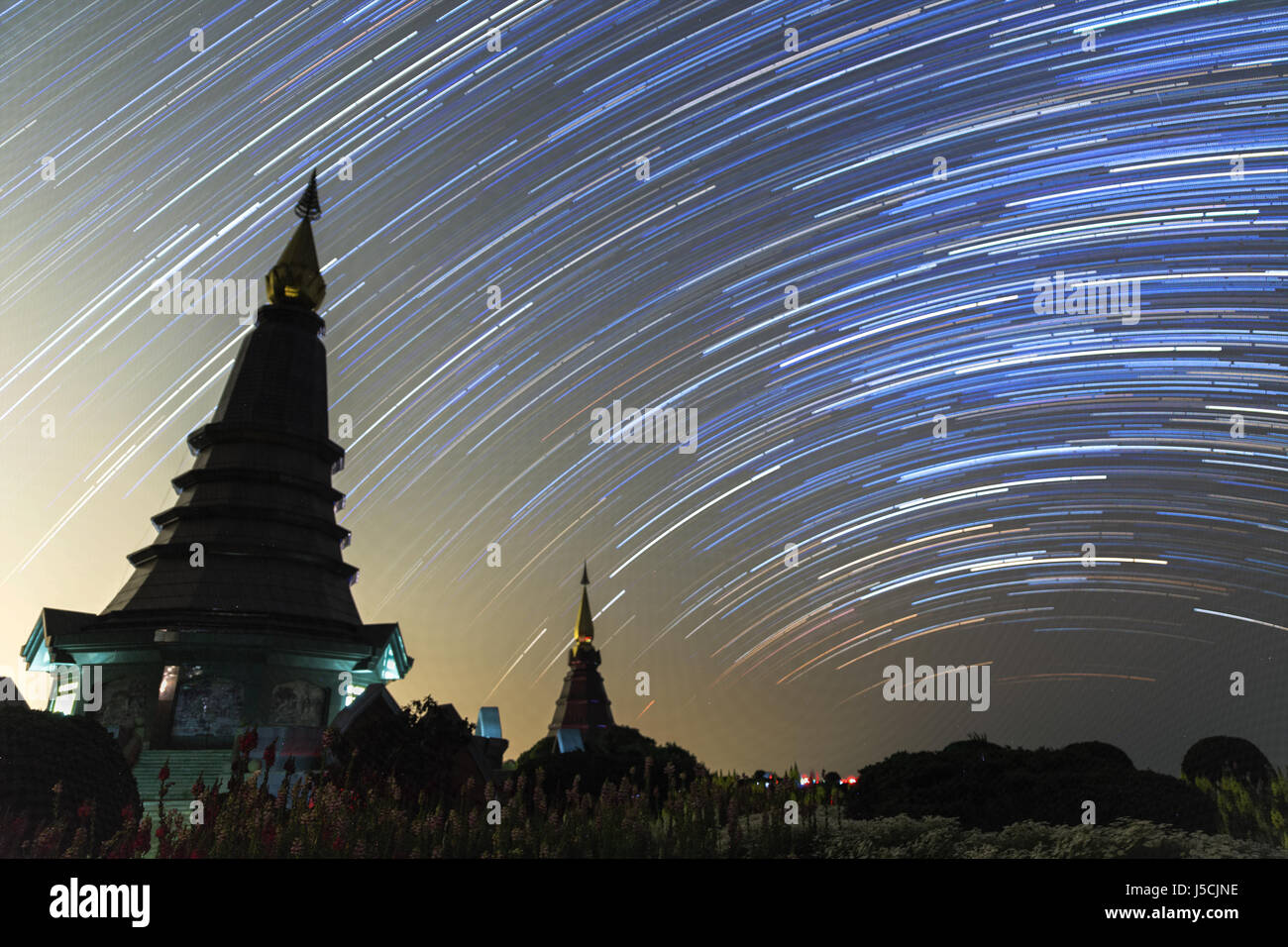 Night sky with star trail and two pagoda in Doi Inthanon mountain ...