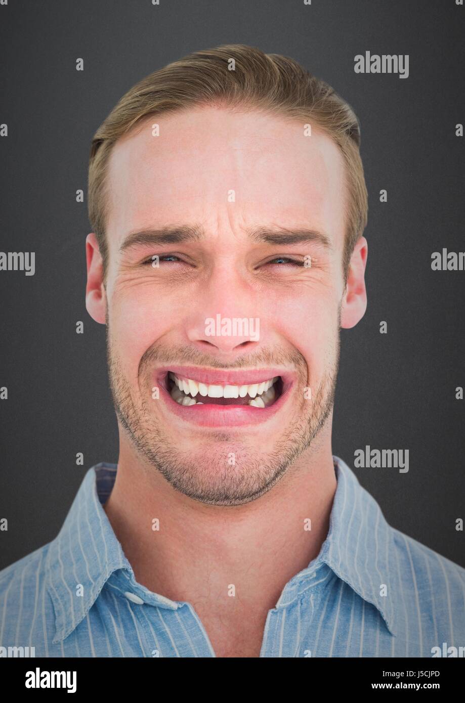 Digital composite of Man crying against grey wall Stock Photo - Alamy