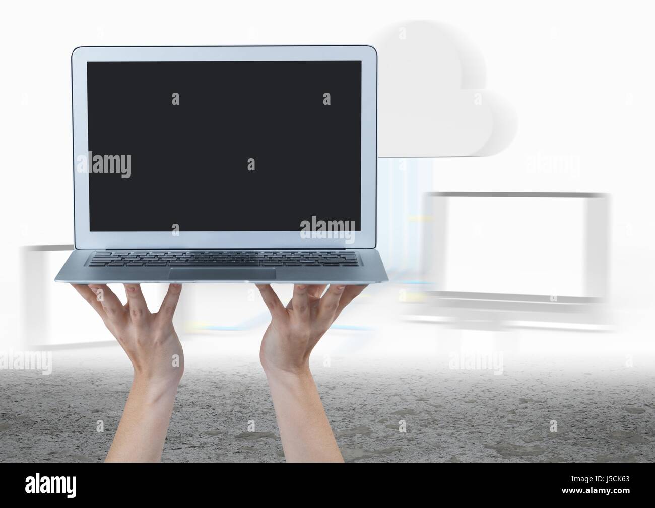 Digital composite of Hands holding laptop against blurry screens Stock ...