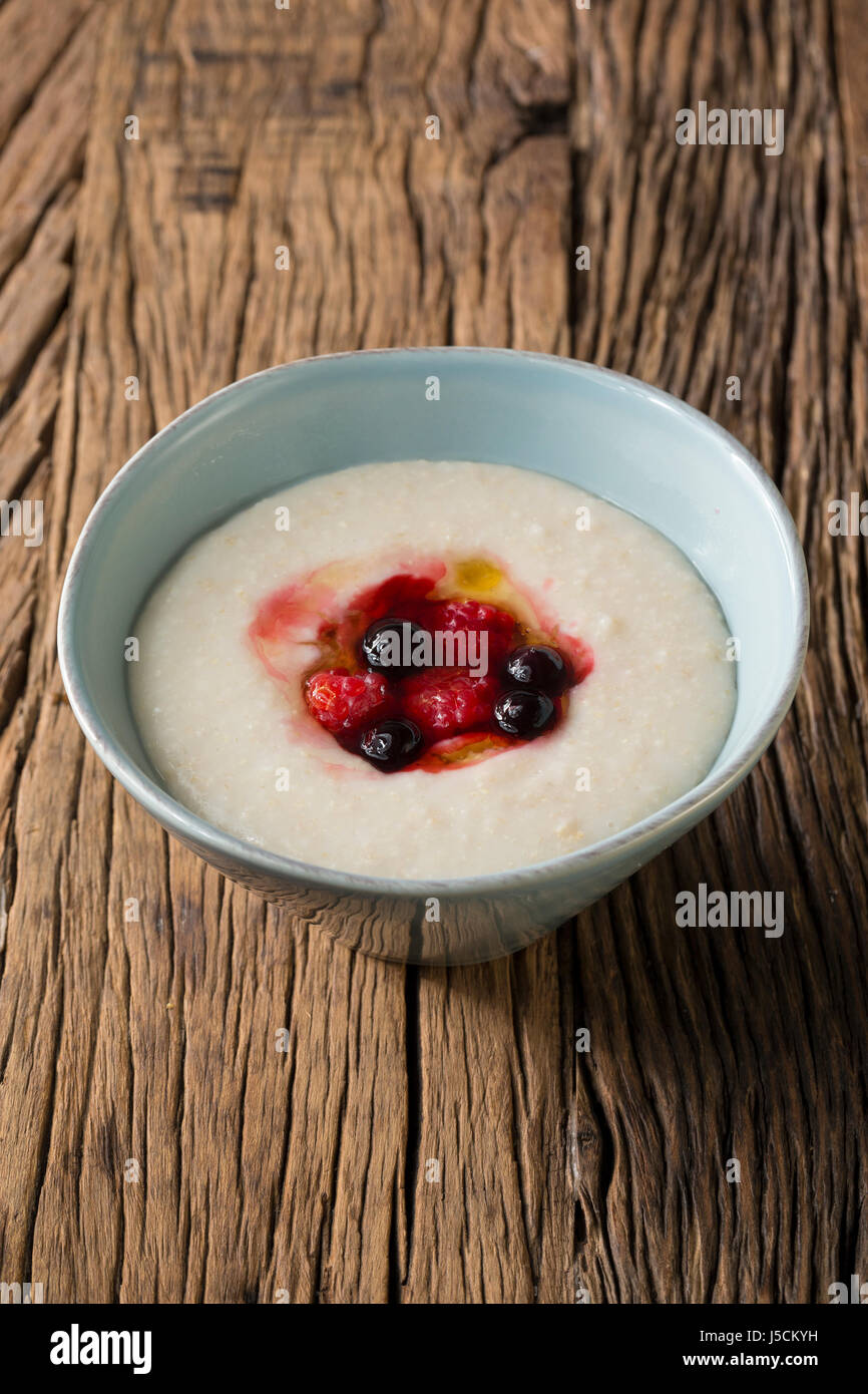 Freshly cooked porridge on a rustic wooden background Stock Photo - Alamy