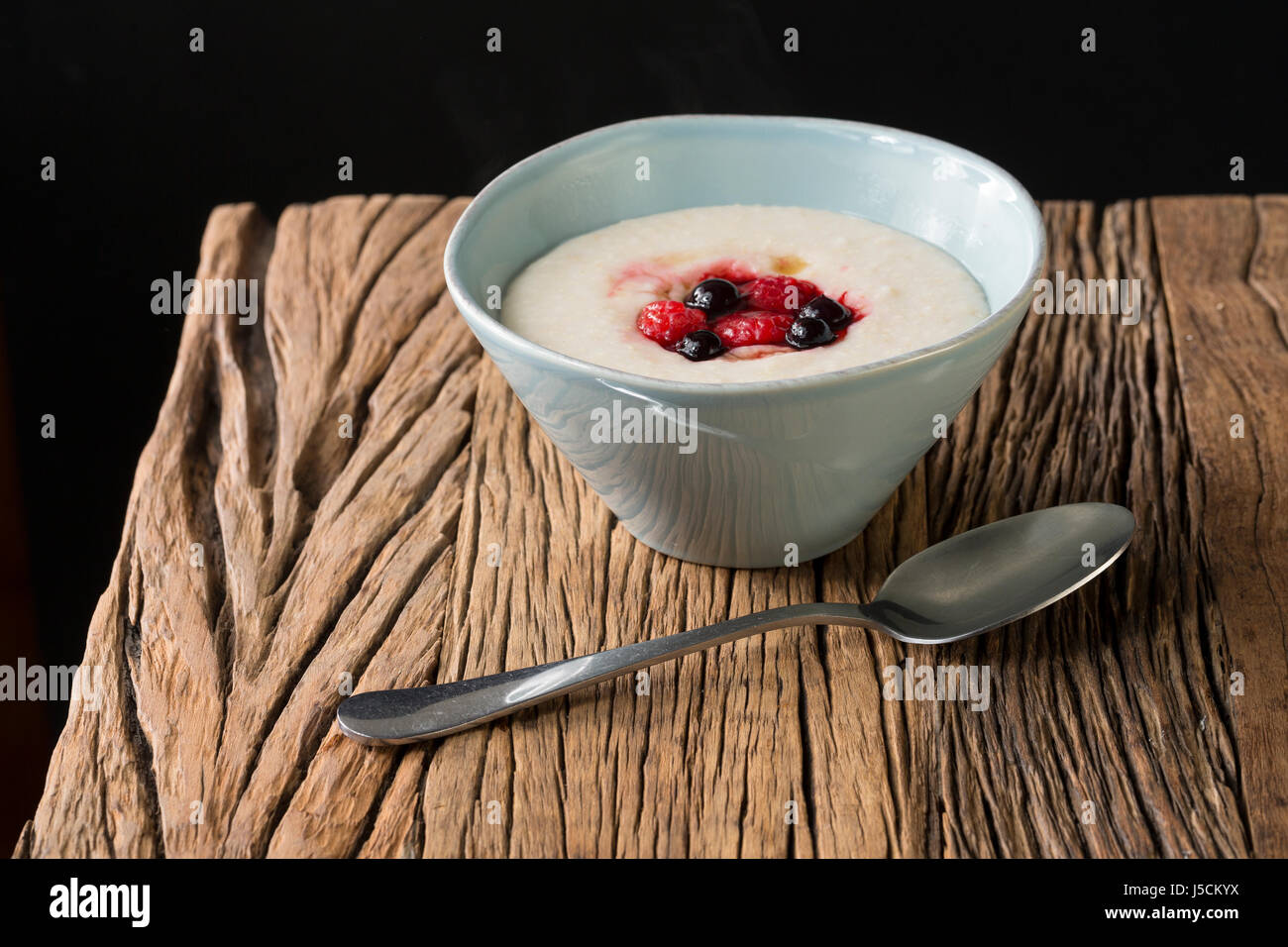 Freshly cooked porridge on a rustic wooden background Stock Photo - Alamy